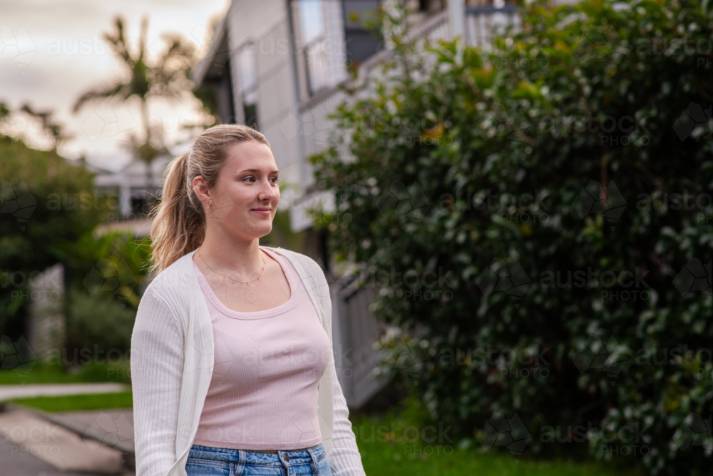 Image of Woman Walking on Suburban Street - Austockphoto