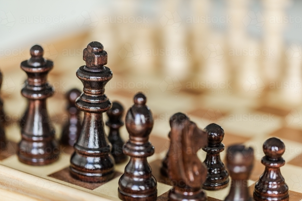 Image of Wooden chess pieces set up on board game indoors - Austockphoto