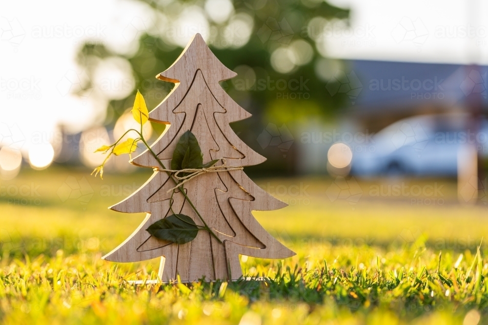 Image of Wooden Christmas tree decoration with gum leaf twig on grass ...