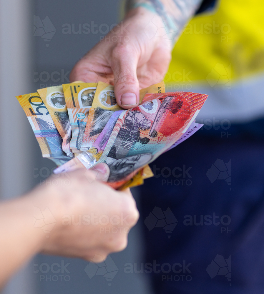 Image of worker giving and receiving money Australian banknotes ...
