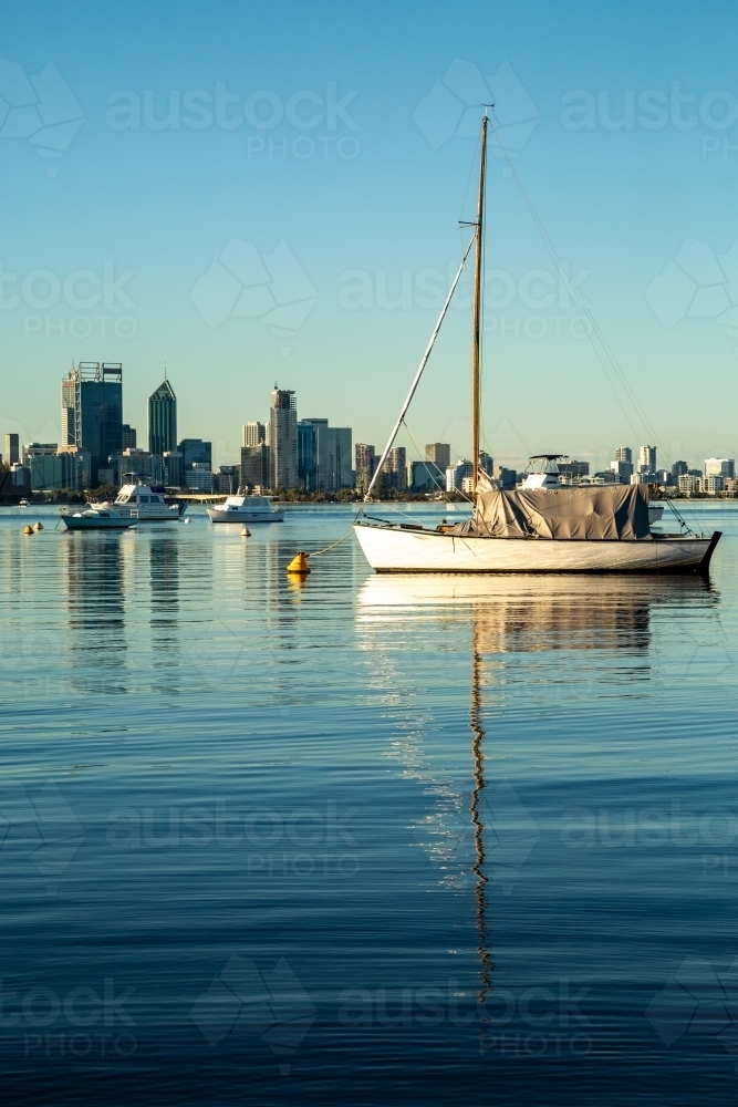 Image of Yacht reflection on water with downtown Perth in background ...