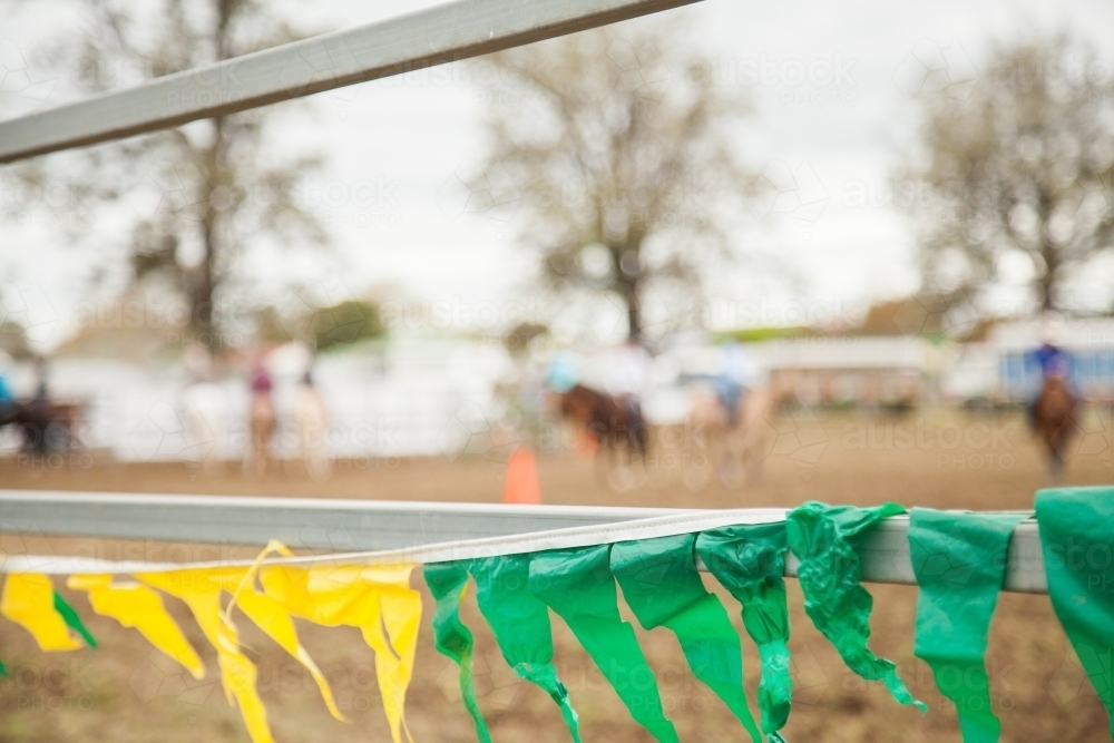 Image of Yellow and green flags along arena fence at the showground ...