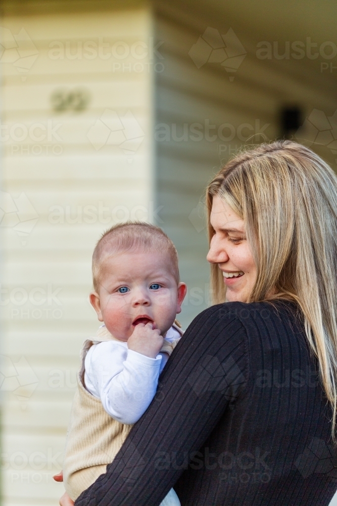 Image of Young aboriginal australian mother smiling at her baby boy ...