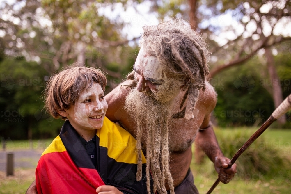 Image of Young Aboriginal boy wearing the Aboriginal flag and being ...