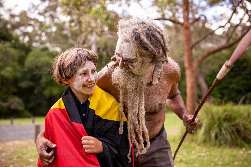 Image of Young Aboriginal boy wearing the Aboriginal flag and being ...