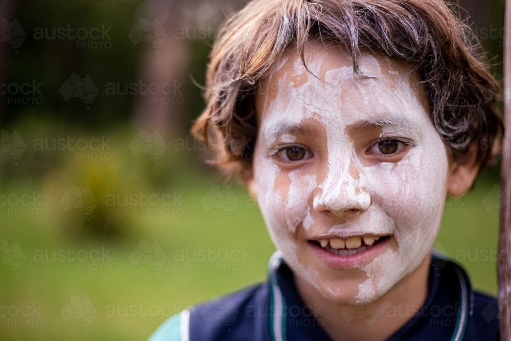 Image of Young Aboriginal boy wearing white face paint smiling at the ...