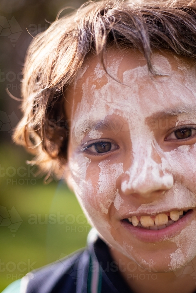 Image of Young Aboriginal boy wearing white face paint smiling ...