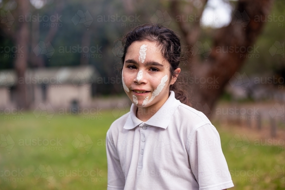Image of Young Aboriginal girl wearing white face paint smiling at the ...