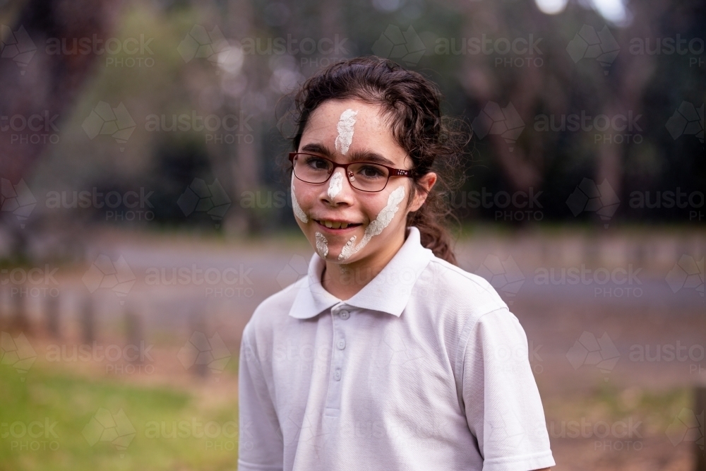 Image of Young Aboriginal girl wearing white face paint smiling at the ...