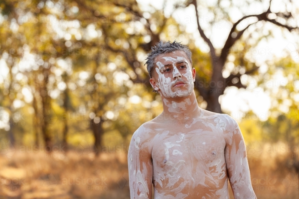Image of Young aboriginal man with neutral expression standing on ...