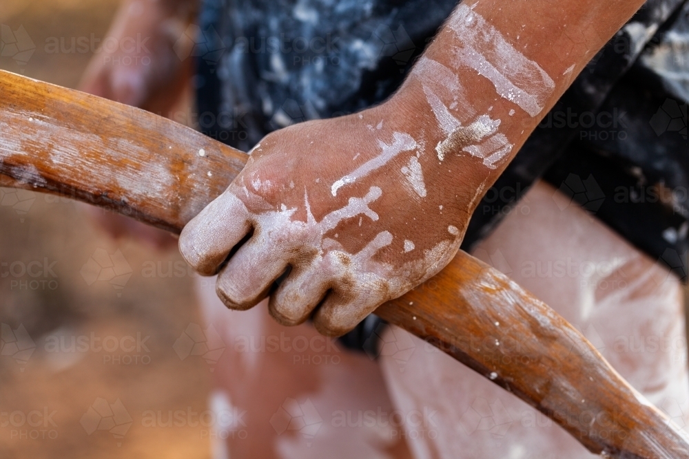 Image of Young aboriginal persons hand holding wooden carved tool for ...