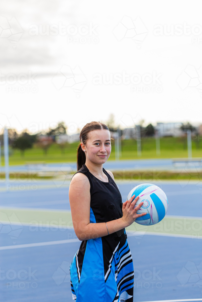 Image of Young aboriginal sports player with ball training for netball ...