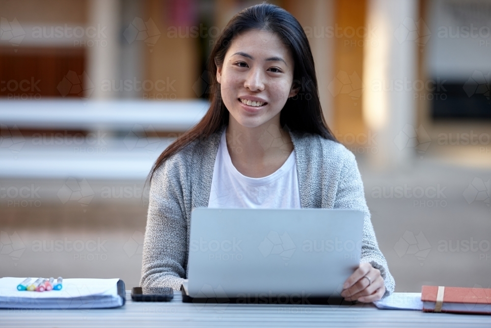 Image of Young Asian female university student studying on laptop ...