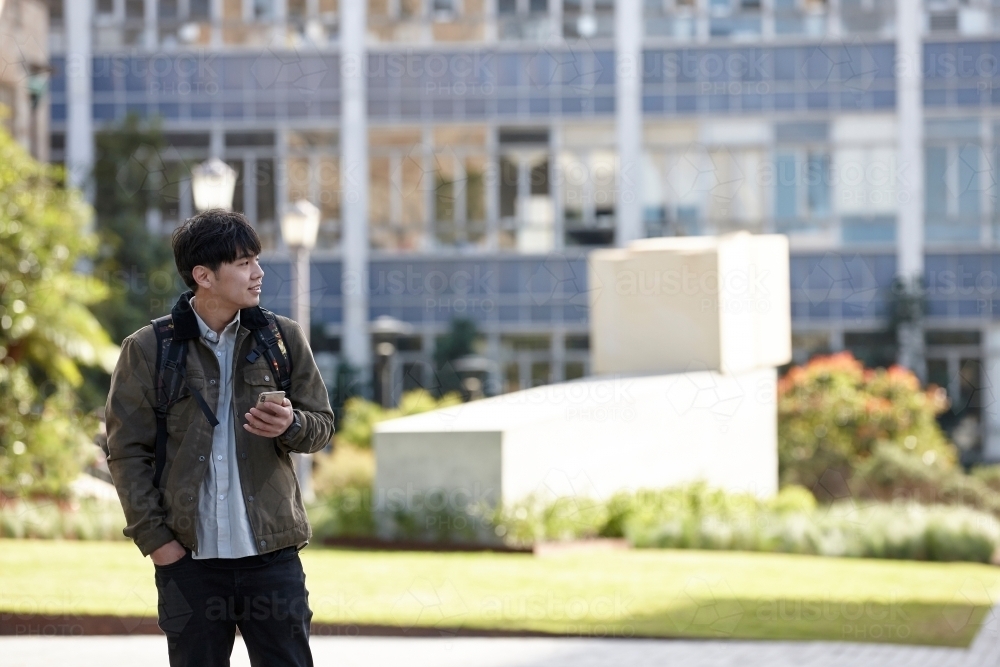 Image of Young Asian university student using mobile phone on-campus ...