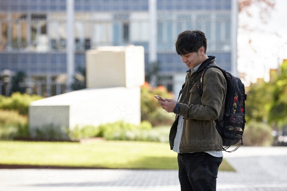 Image of Young Asian university student using mobile phone on-campus ...