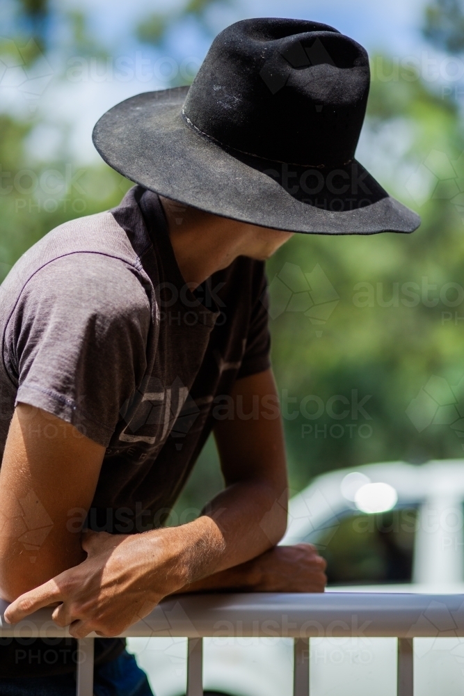 Image of Young Aussie man with indigenous heritage leaning on fence ...