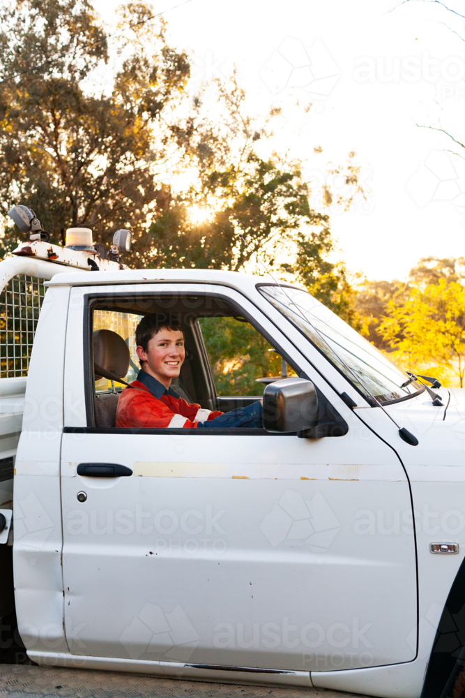 Image of Young Aussie teenager driving ute on Australian farm wearing ...