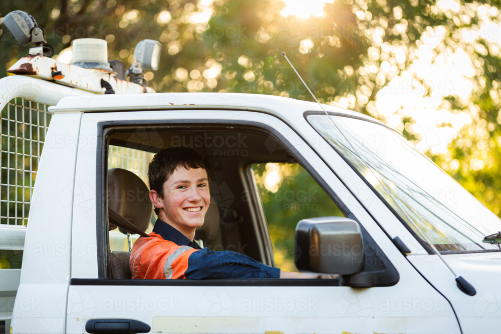Image of Young Aussie teenager driving ute on Australian farm wearing ...