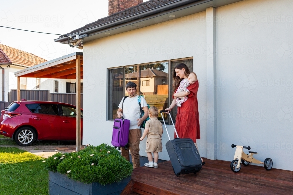 Image of Young Australian family with small children leaving home with ...