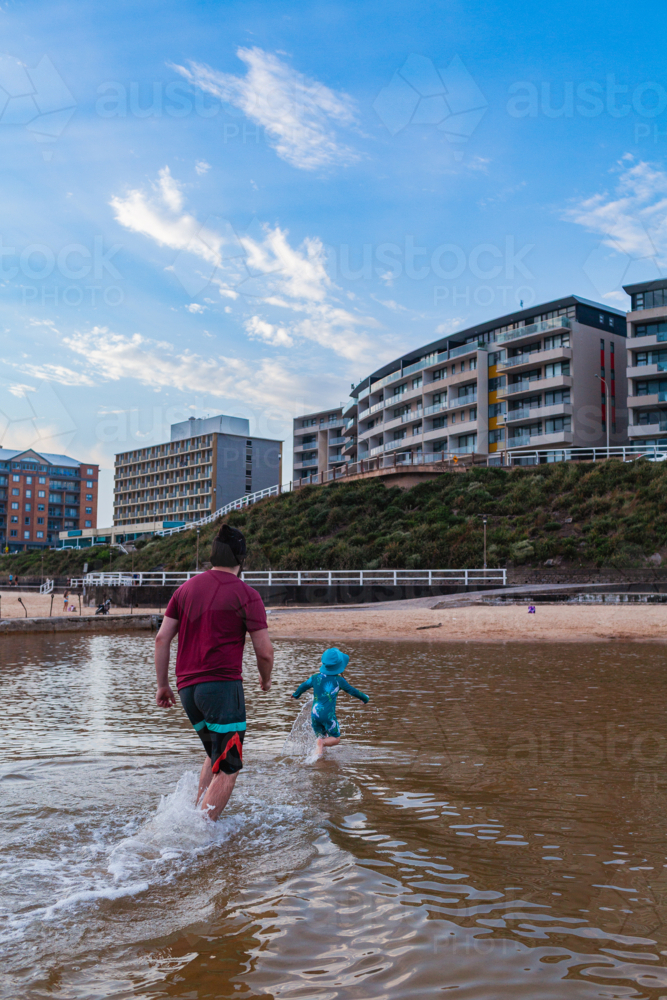 Image of Young Australian man playing with daughter at Newcastle Beach ...