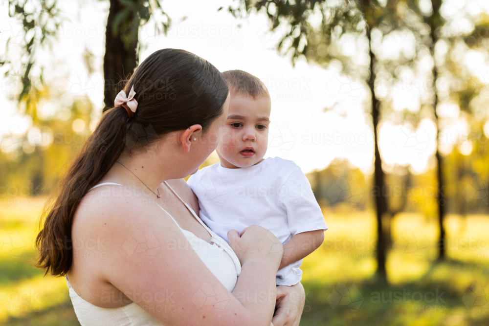 Image of Young Australian mum holding Aboriginal toddler son in rural ...