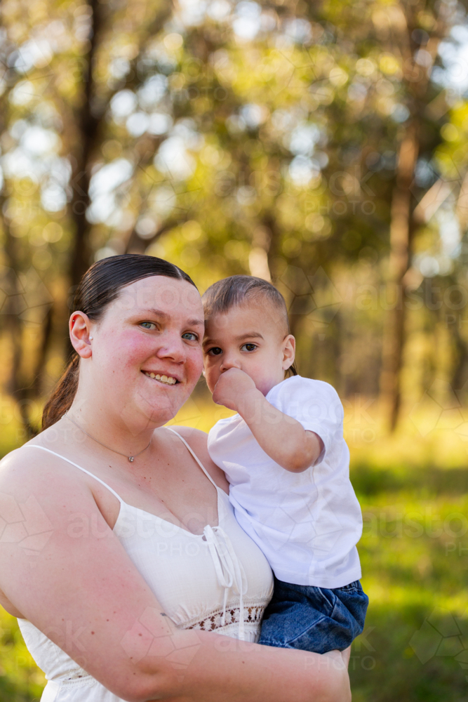 Image of Young Australian mum holding Aboriginal toddler son in rural ...