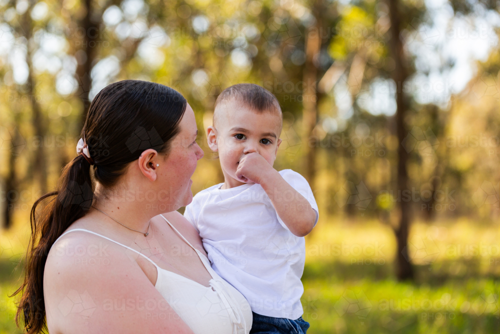 Image of Young Australian mum holding Aboriginal toddler son in rural ...