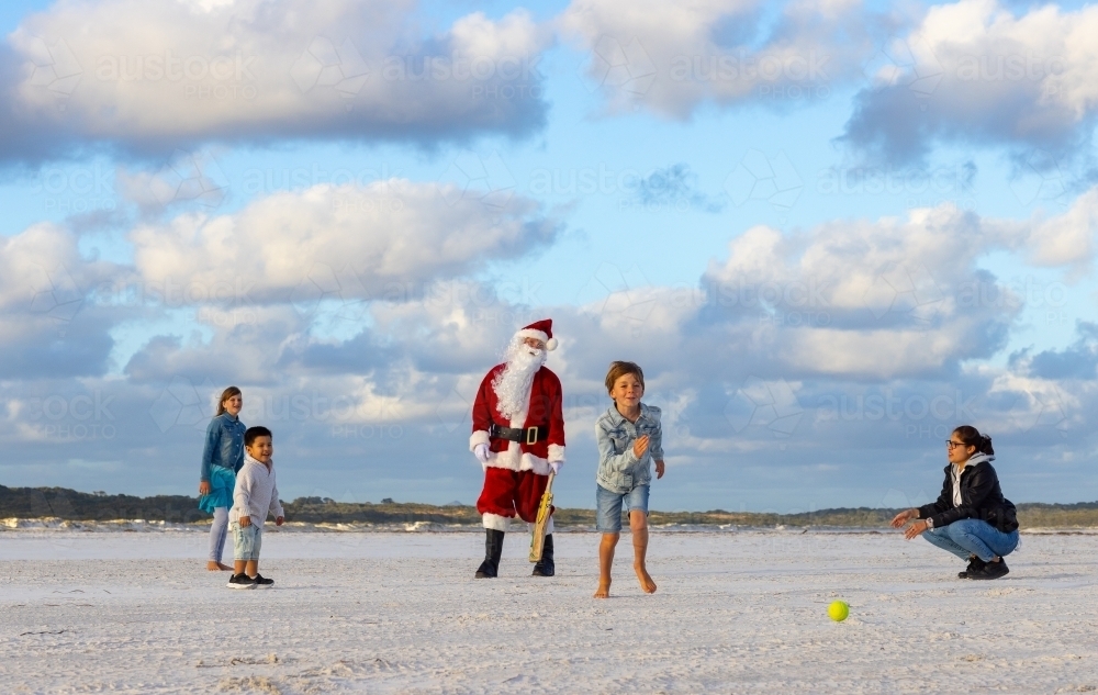 Image of young boy chasing after a tennis ball hit by santa playing ...