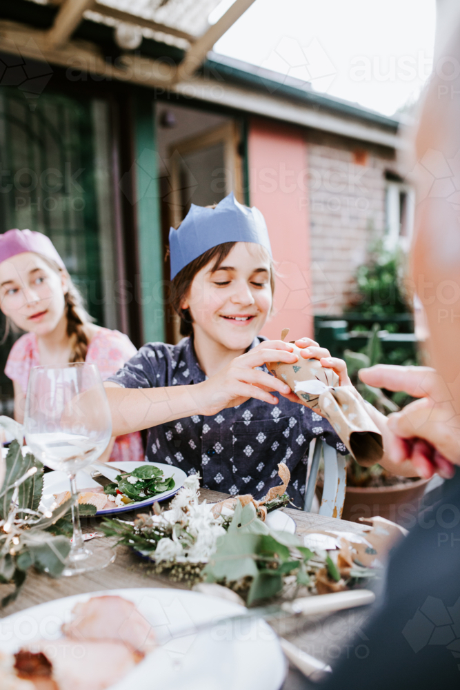 Image of Young boy holding a Christmas cracker - Austockphoto