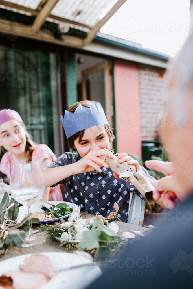 Image of Young boy holding a Christmas cracker - Austockphoto