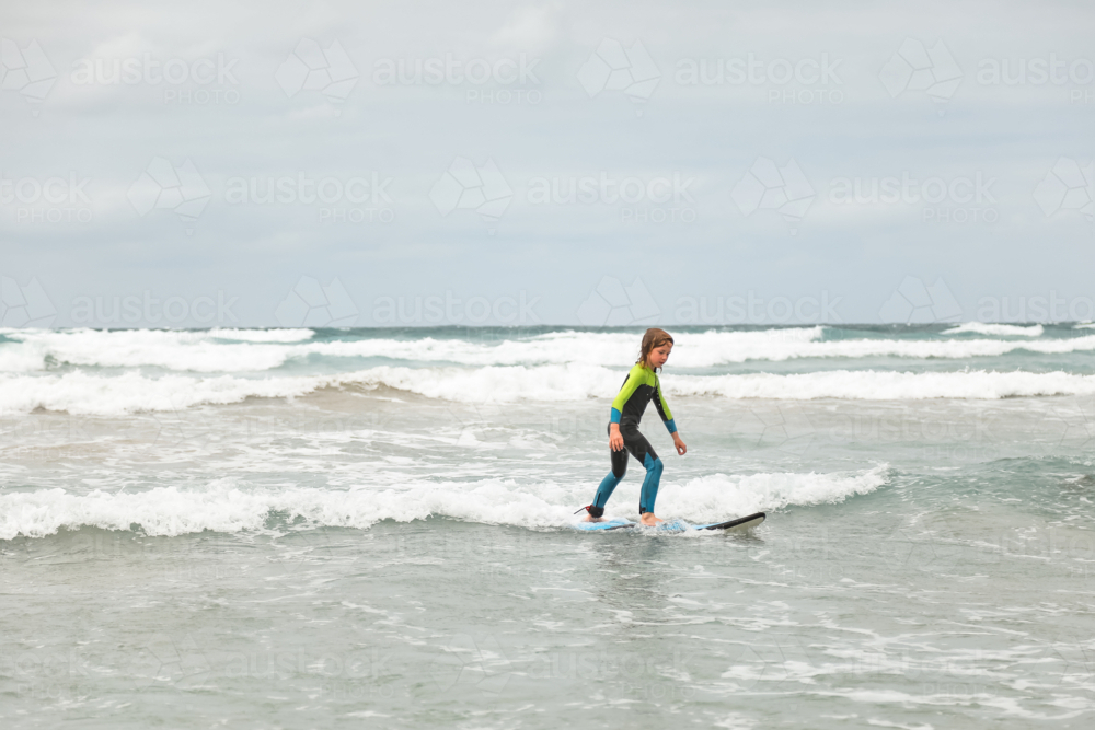 Image of Young boy learning to surf in Portland Victoria - Austockphoto