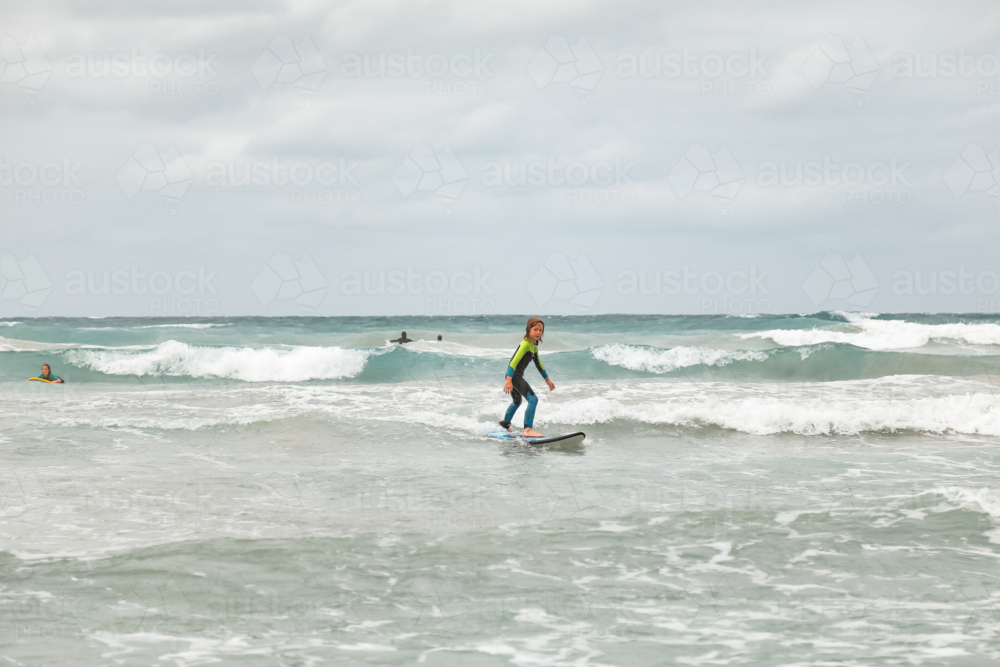 Image of Young boy learning to surf in Portland Victoria - Austockphoto