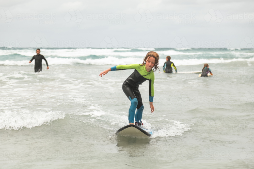 Image of Young boy learning to surf in Portland Victoria - Austockphoto
