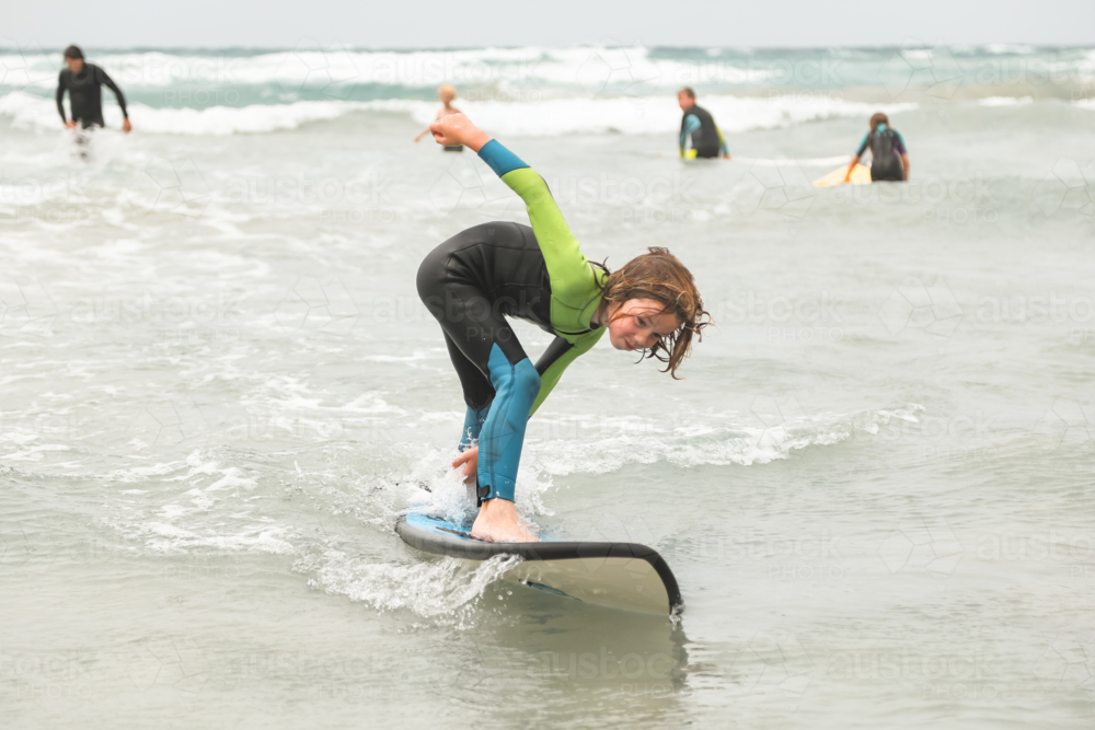 Image of Young boy learning to surf in Portland Victoria - Austockphoto