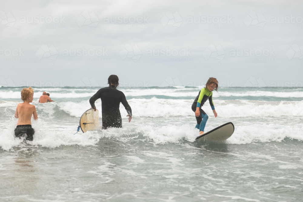 Image of Young boy learning to surf in Portland Victoria - Austockphoto