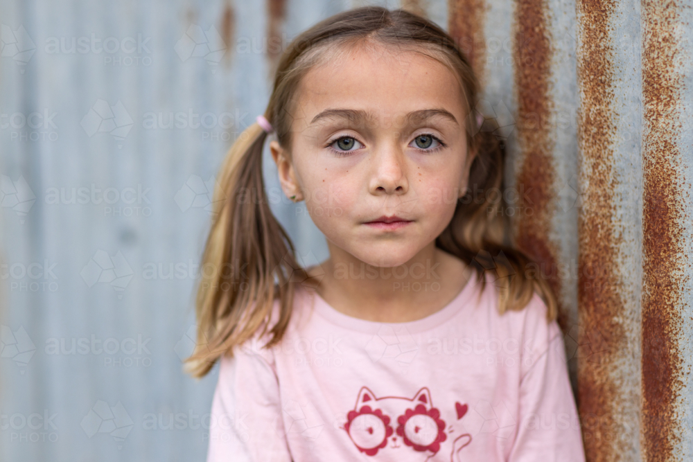 Image of young caucasian girl with straight hair in piggy tails leaning ...