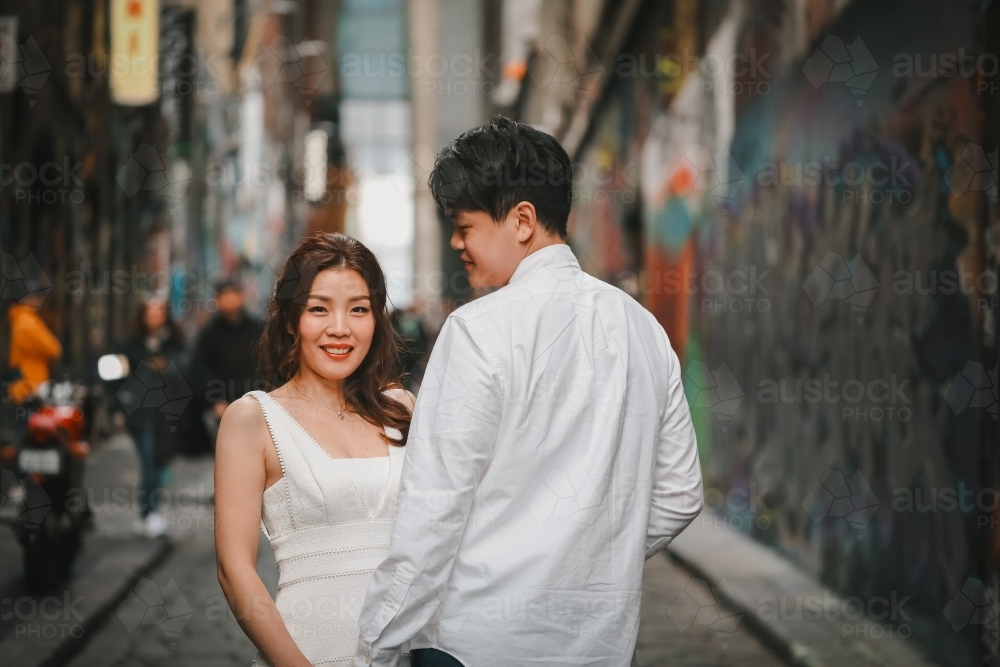 Image of Young engaged couple posing together in Hosier Lane, iconic ...