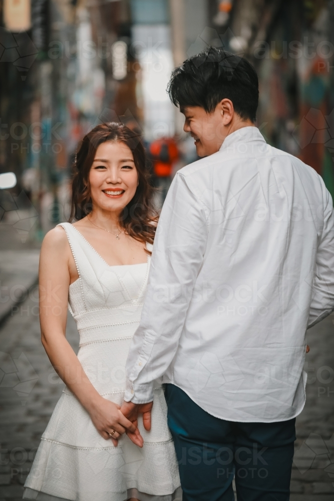 Image of Young engaged couple posing together in Hosier Lane, iconic ...
