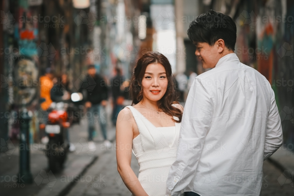 Image of Young engaged couple posing together in Hosier Lane, iconic ...