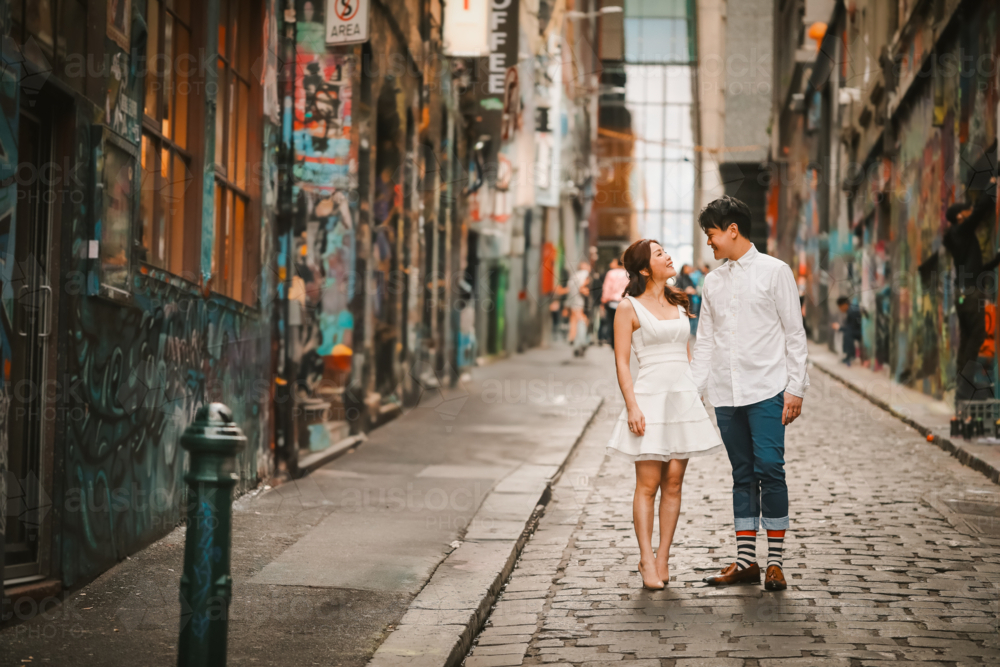 Image of Young engaged couple posing together in Hosier Lane, iconic ...