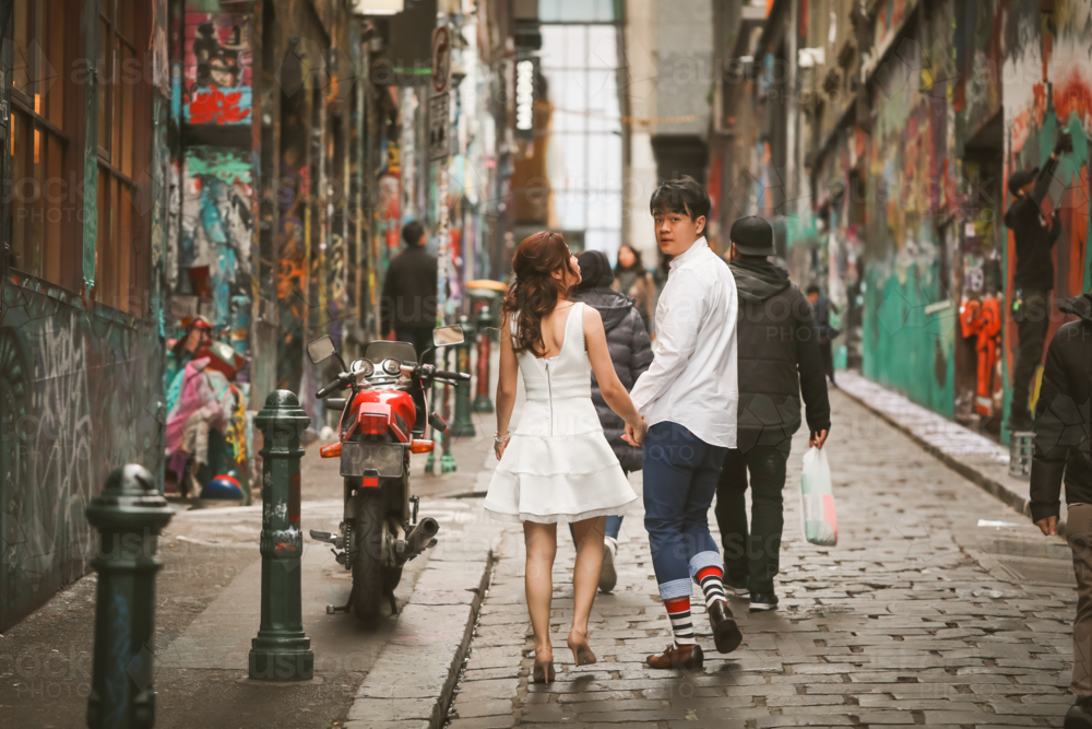 Image of Young engaged couple posing together in Hosier Lane, iconic ...