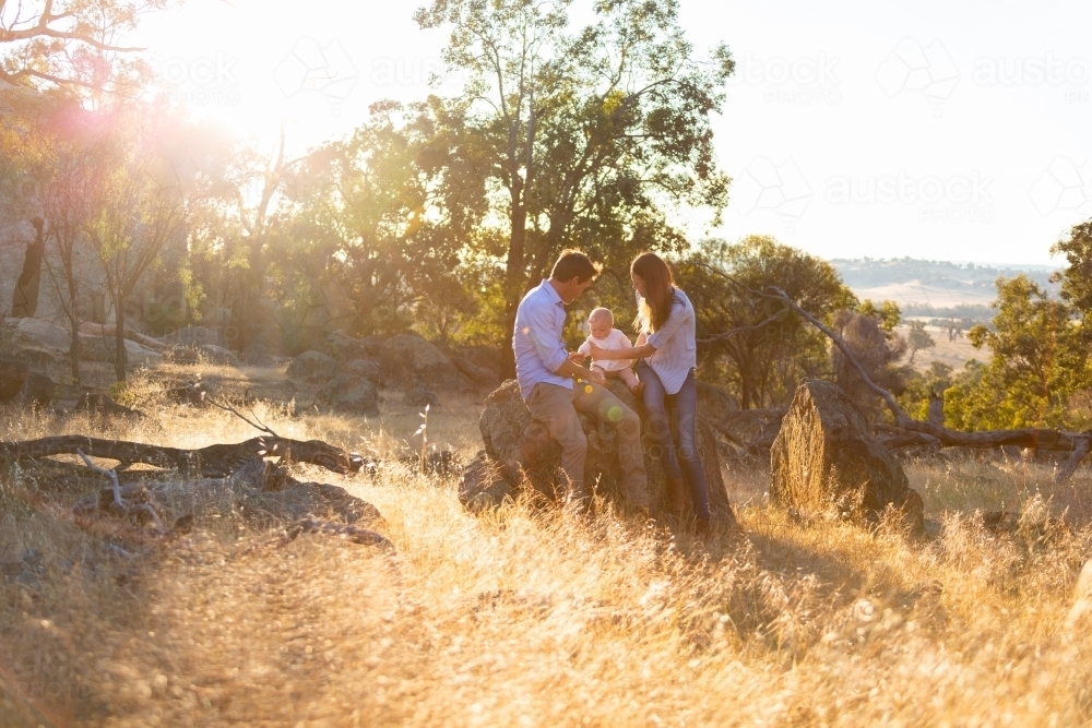 Image of Young family in country setting - Austockphoto