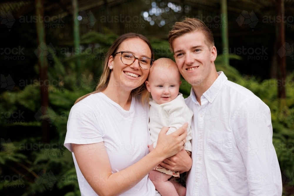 Image of Young family of 3 with small baby at the park - Austockphoto