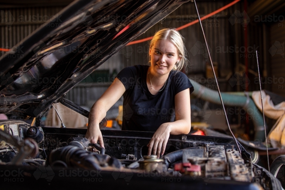 Image of young female australian tradesperson mechanic working on car ...