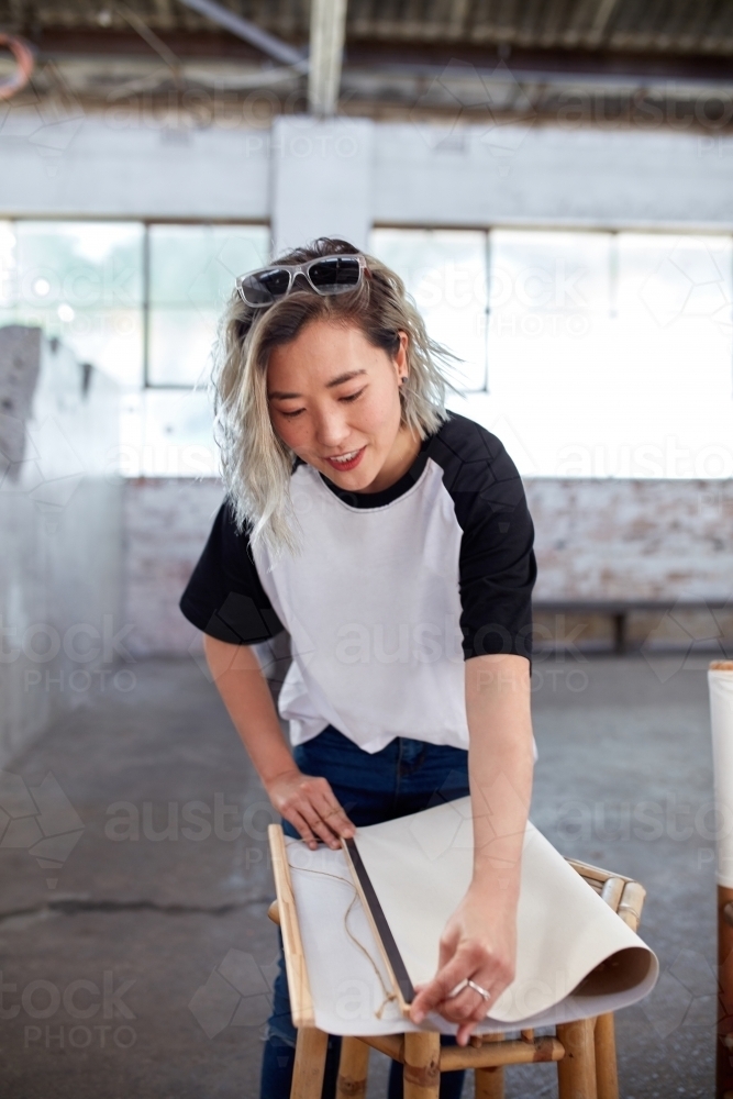 Image of Young female event planner working on set with stylists ...