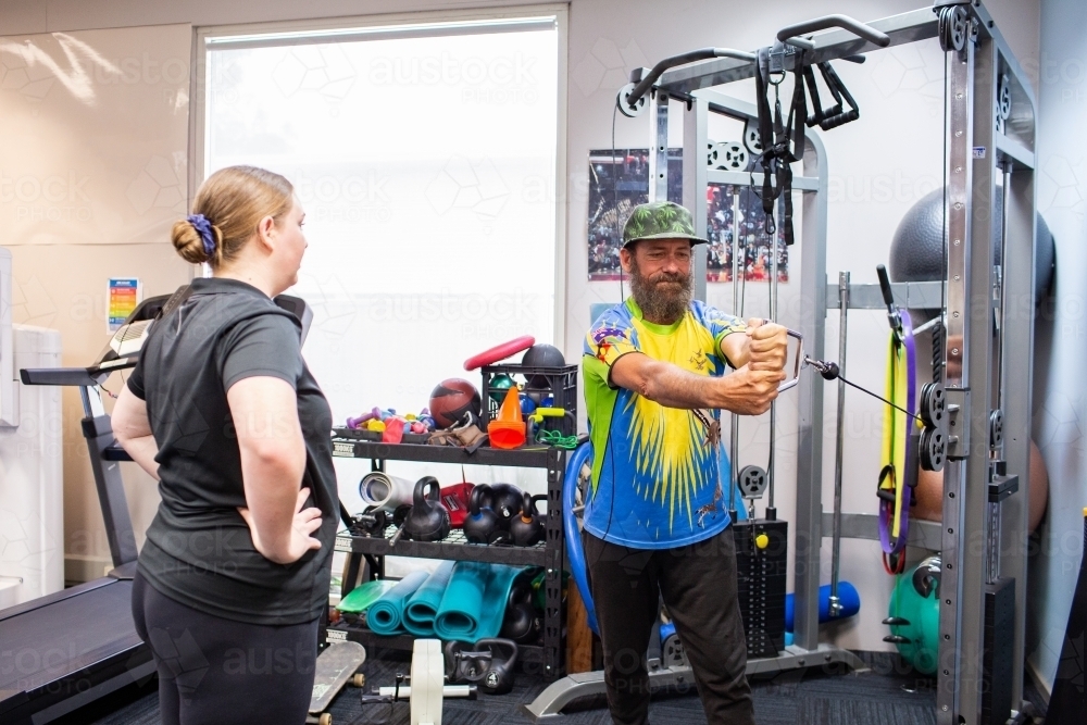 Image of Young female physio working with aboriginal australian client ...