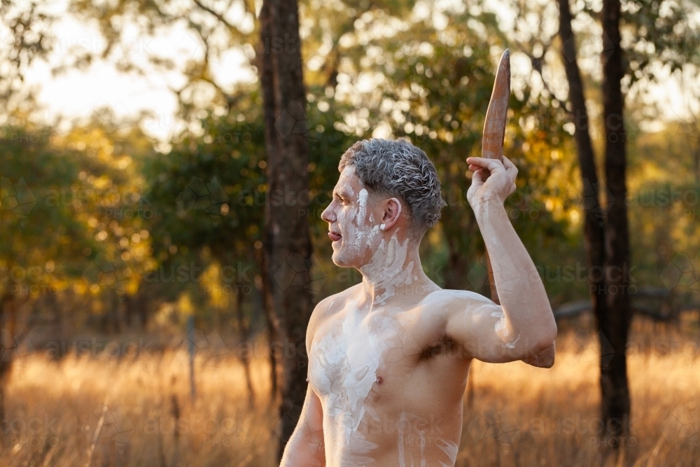 Image of Young First Nations Australian man holding up digging and ...