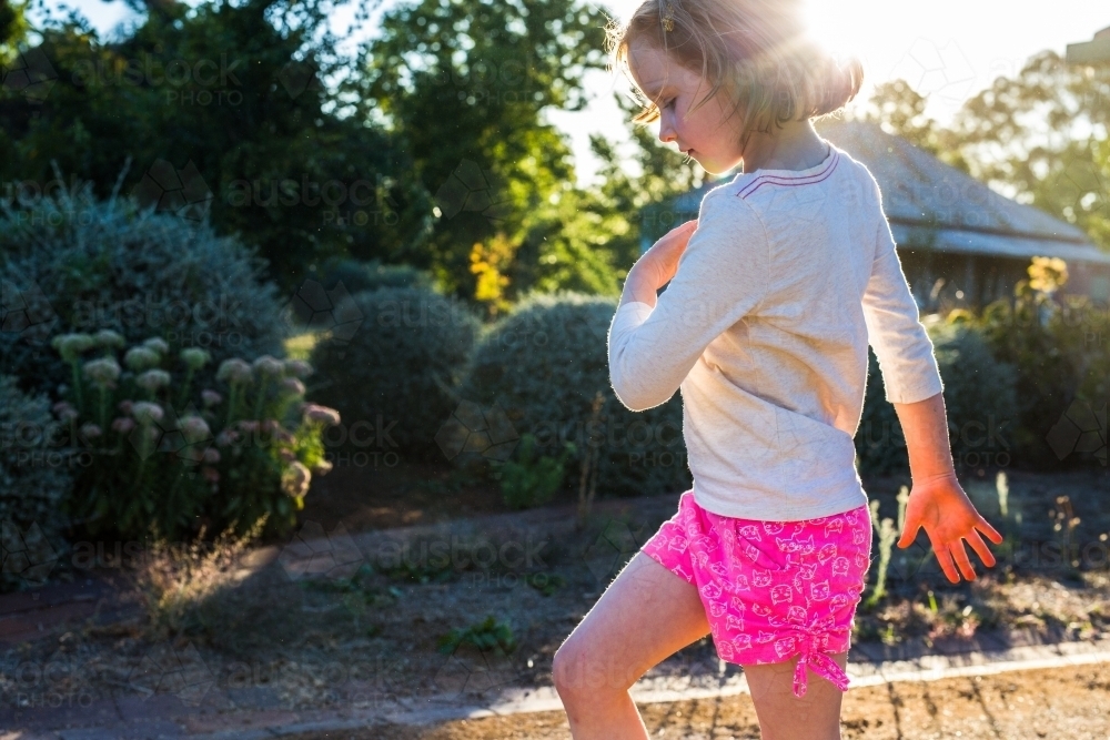 Image of Young girl marching in the garden - Austockphoto