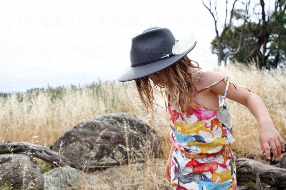 Image of Young girl wearing grey bushman's hat in grassy fields ...