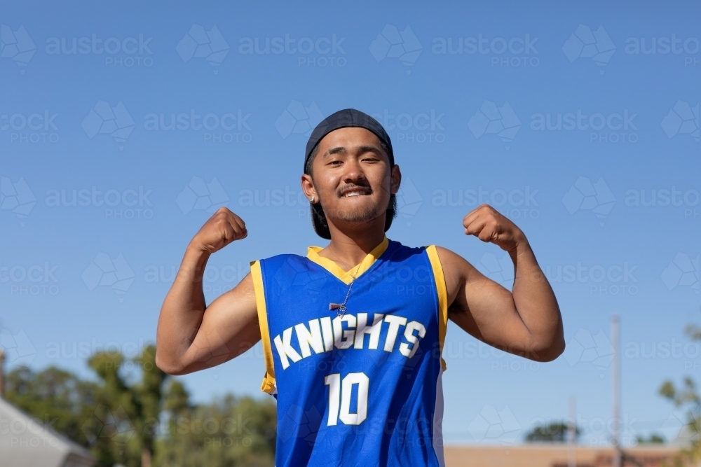 Image of young guy flexing his muscles and being fierce - Austockphoto